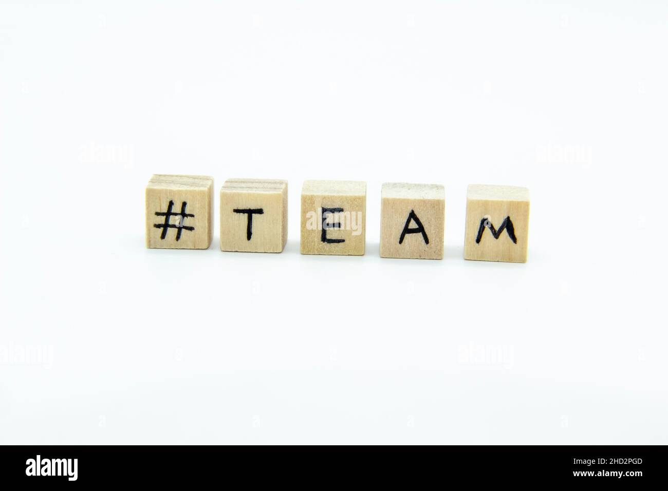 Word TEAM written on the wood cubes on white background. The concept ...