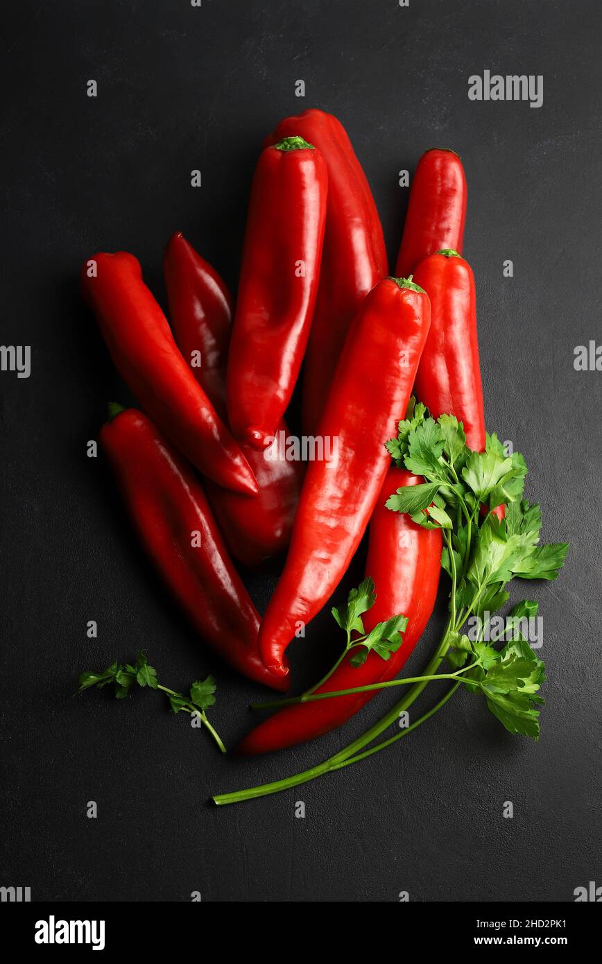 Group of fresh horn peppers on black background. Directly above Stock ...