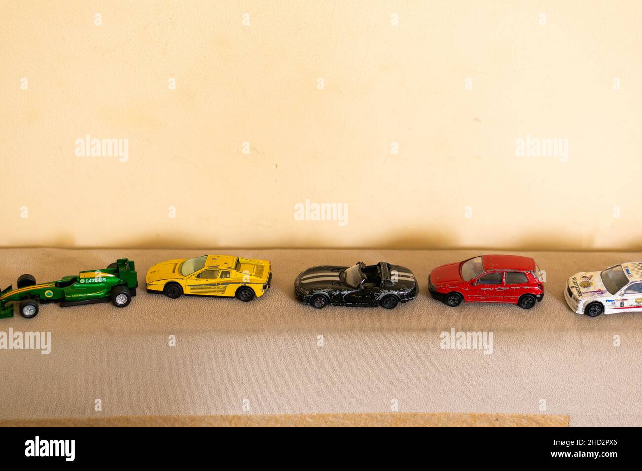 Closeup of a row of different model toy vehicles including colorful ...
