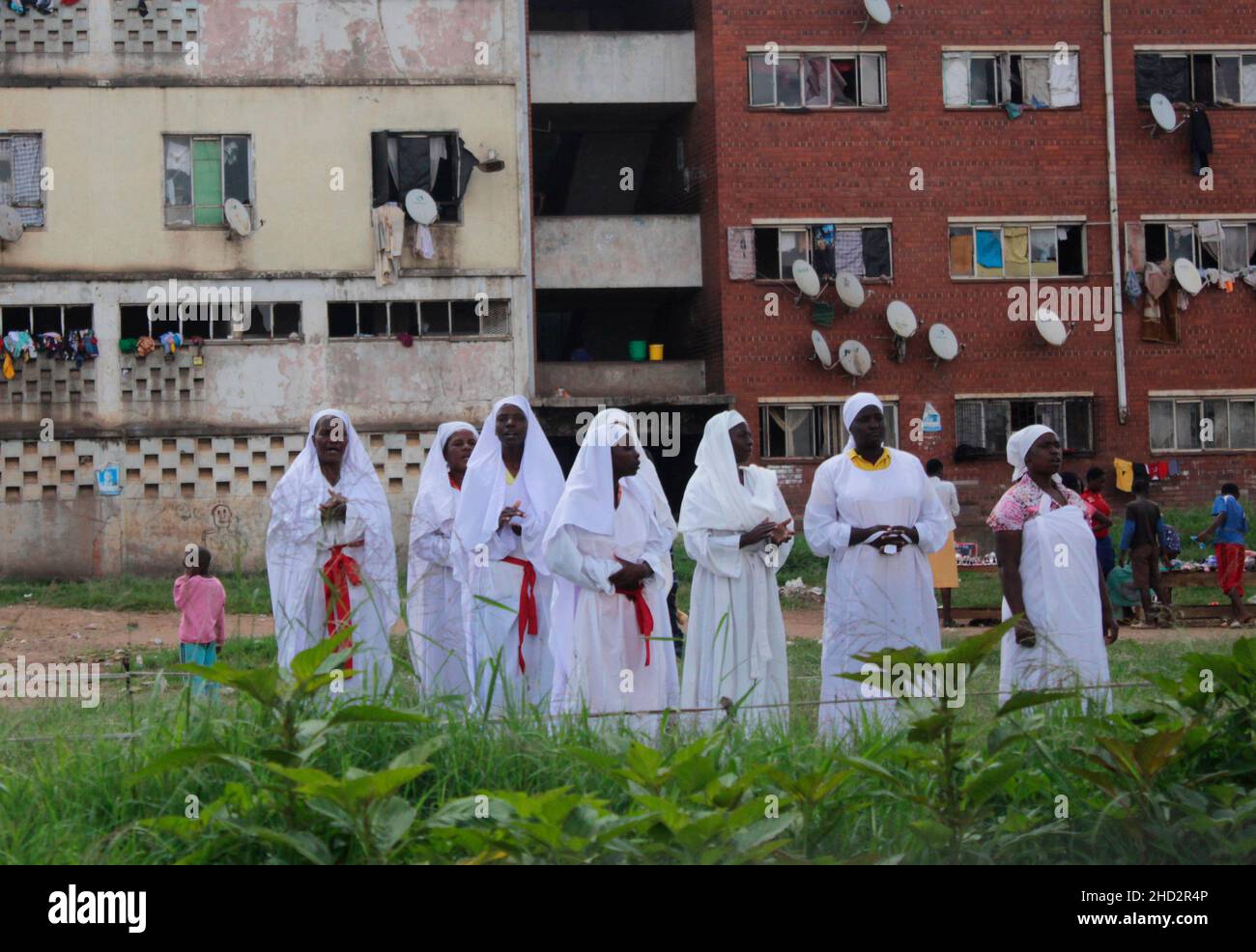 Women from the apostolic faith sect are seen praying outside Mbare ...