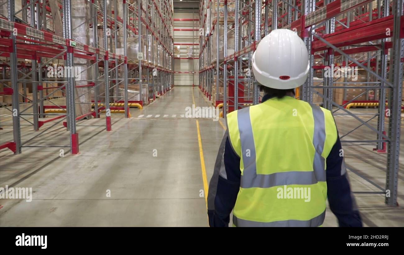 Shot of Female Industrial Worker in the Hard Hat Walking Through Heavy ...