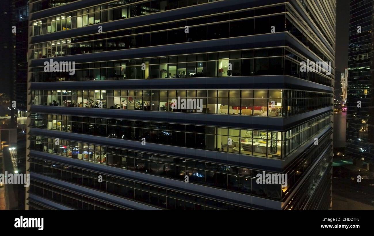 Bright and beautiful lights reflection in night windows of business ...