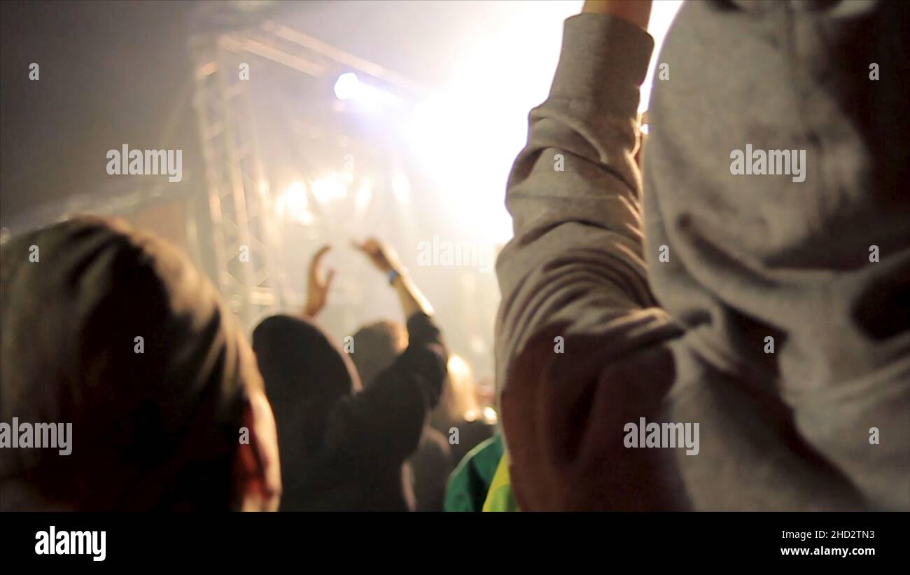Back view of crowd of people at the concert. Silhouettes of concert ...