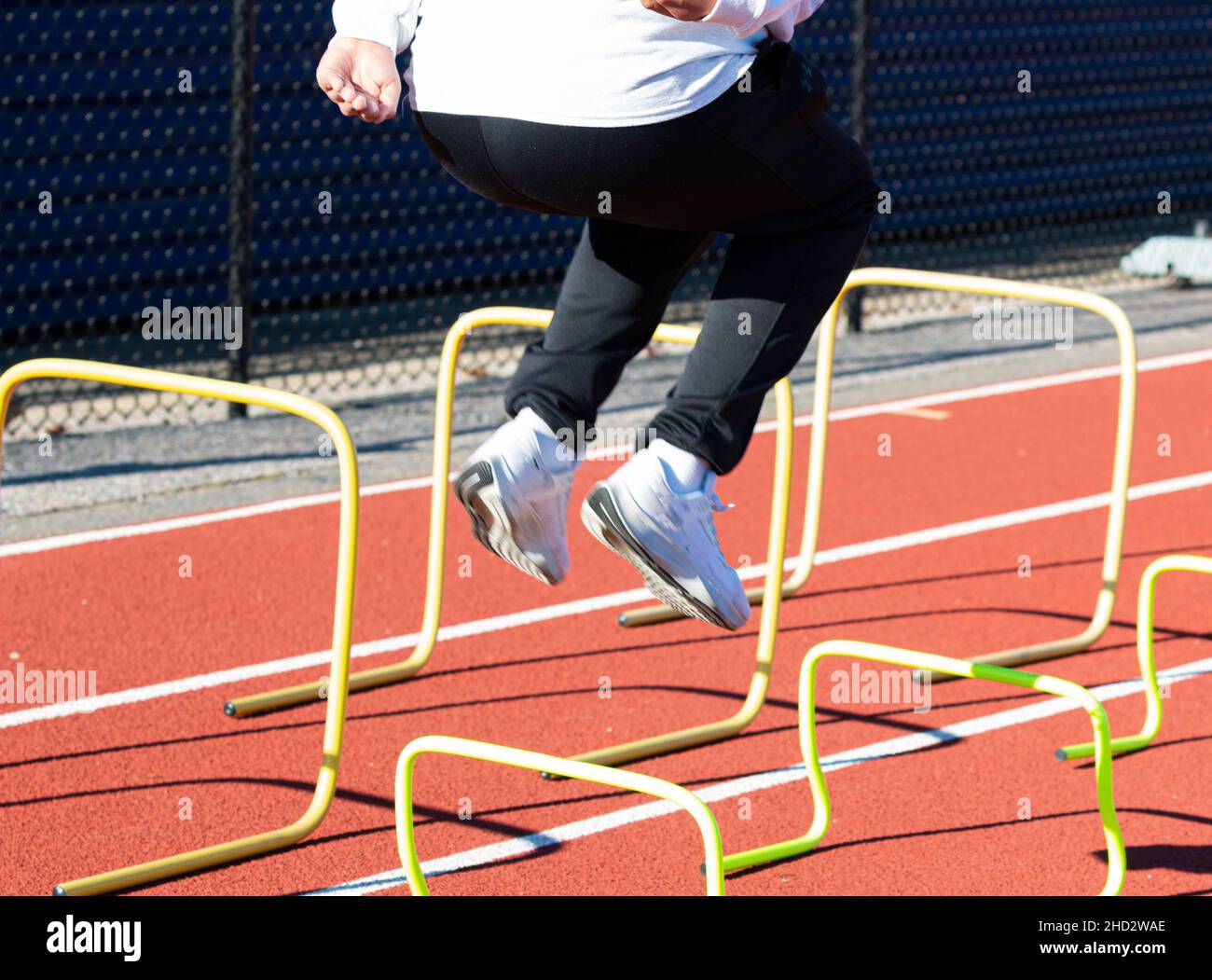 Side rear iw of a young high school athlete is boundind over small ...
