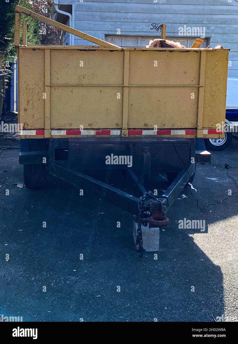 Front view of a portable dumpster in a residential homes driveway full ...