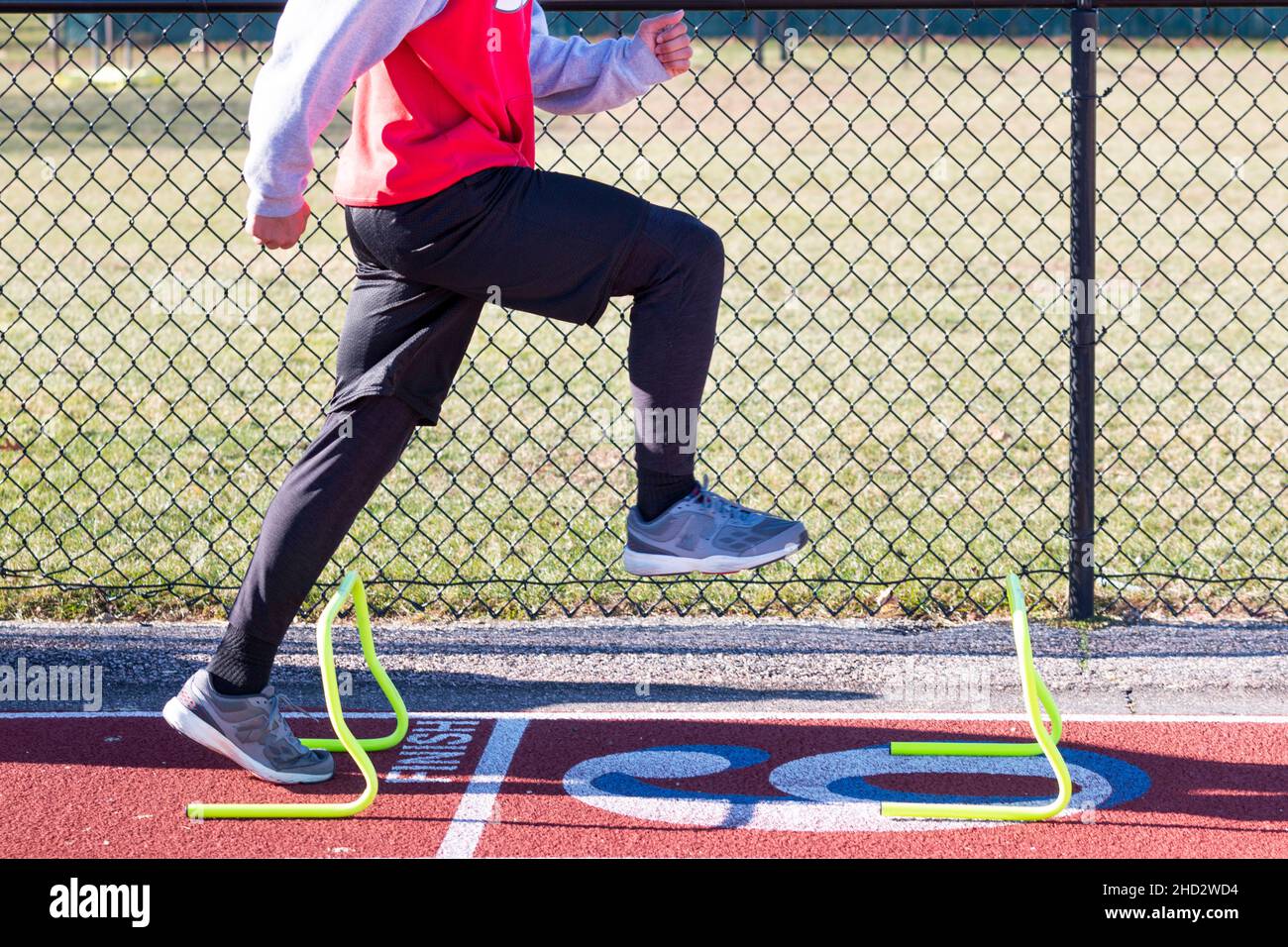 Side View of a high school track and field runner standing in the A ...