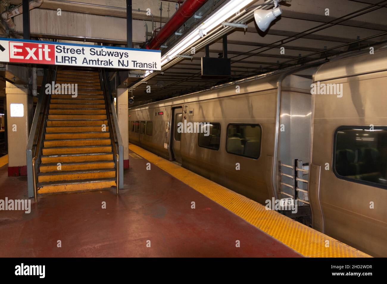 Long Island Railroad train leaving Penn Statiion passing the exit sign ...
