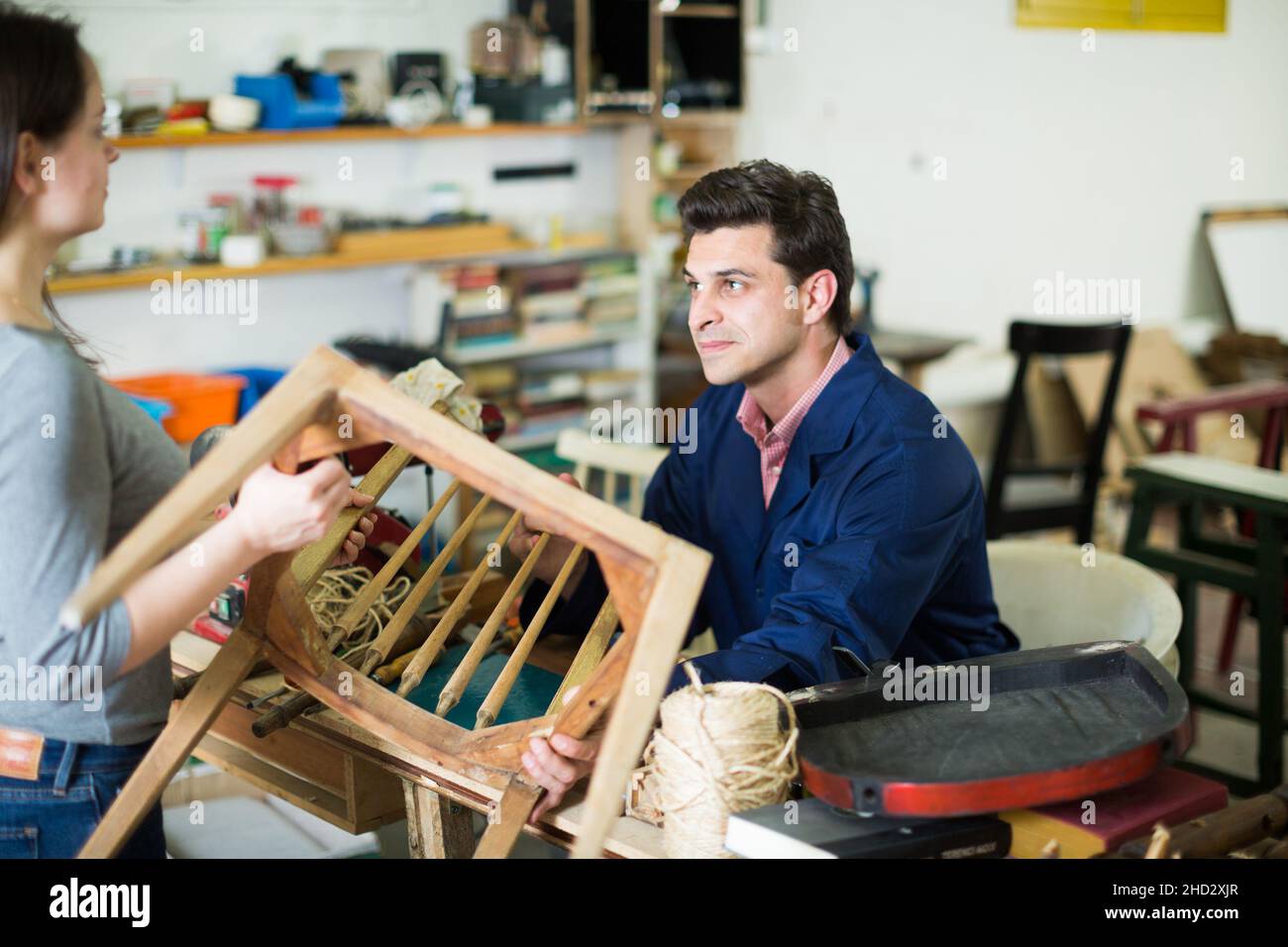 Carpenter taking chair for repairing Stock Photo - Alamy