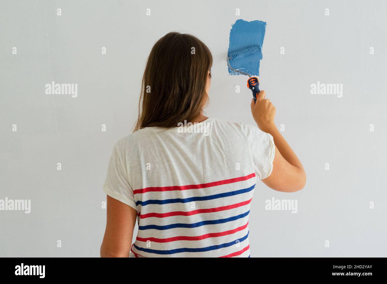 Woman painting wall Stock Photo - Alamy