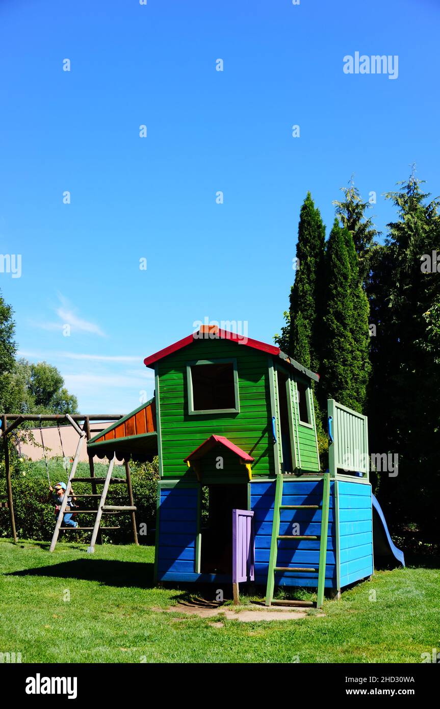 Children playing by a wooden green hut of a playground in Hortulus ...