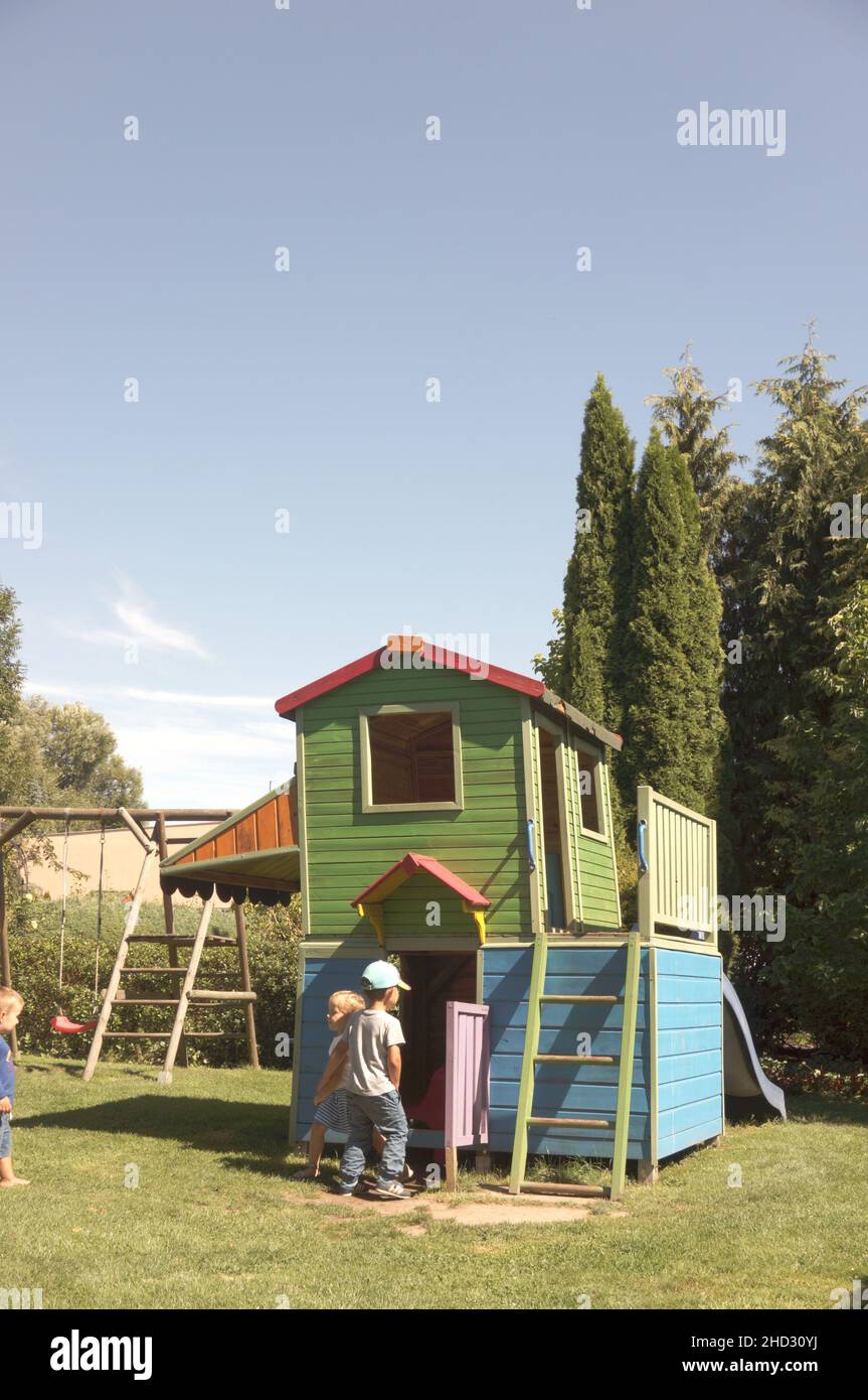 Children playing by a wooden green hut of a playground in Hortulus ...