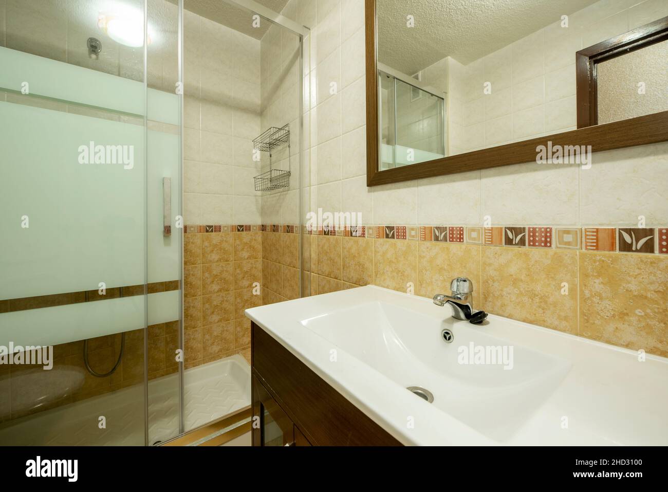 Dark cream toilet with white sink and shower with screen in the ...