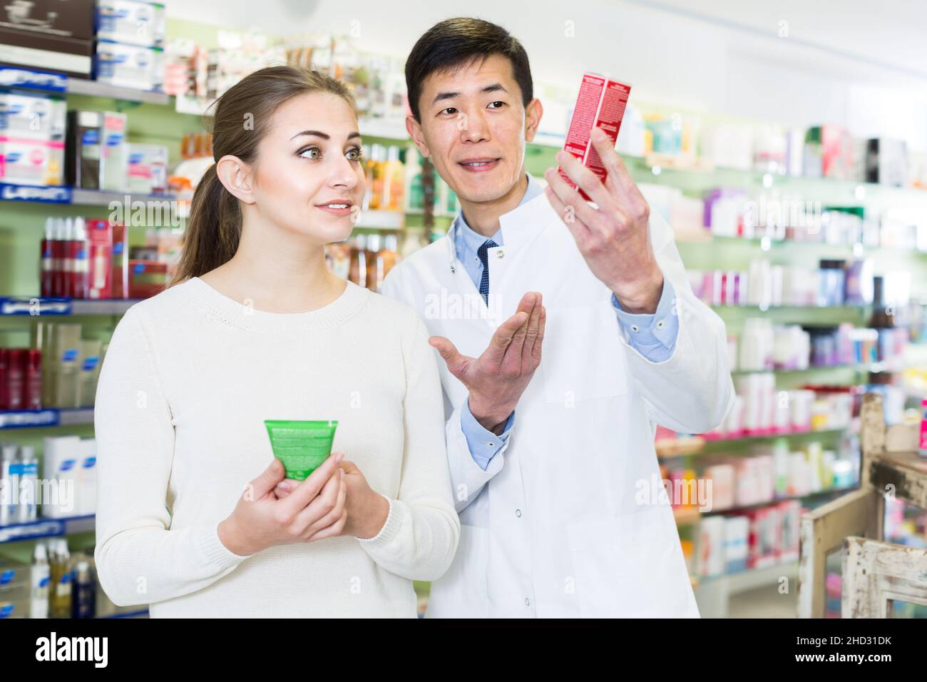 Happy client asking pharmacist about medicines Stock Photo - Alamy