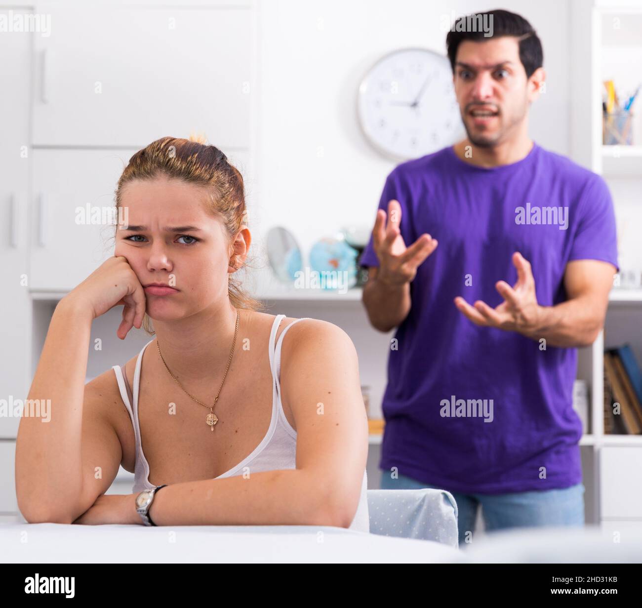 Frustrated girl at table with angry boyfriend Stock Photo - Alamy