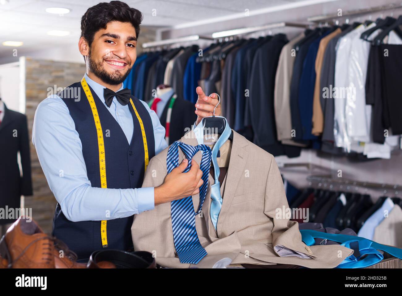Fashion designer is picking up a tie for light jacket Stock Photo - Alamy