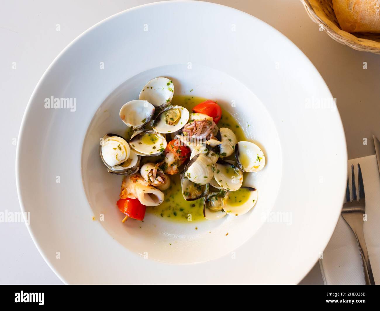 Squid skewer with garlic and clams Stock Photo - Alamy