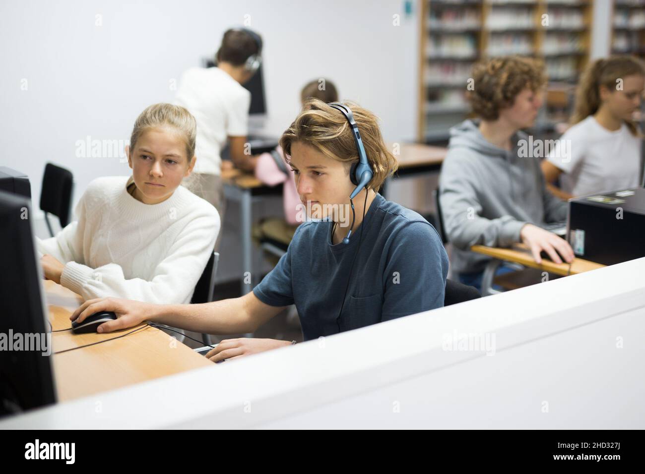 Teenage student in headphones at the computer in school class Stock ...