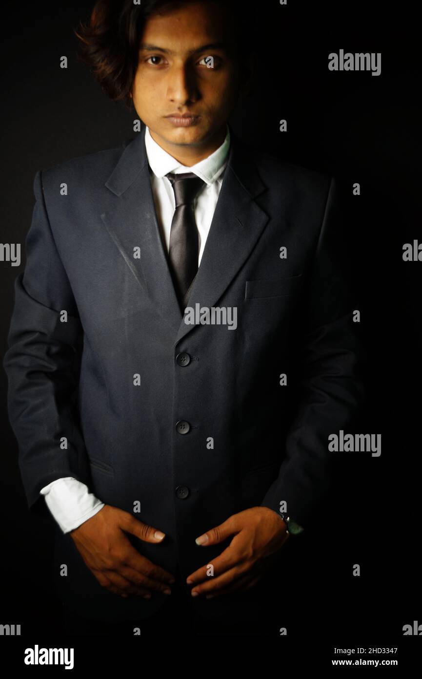 Vertical shot of a handsome Indian man wearing a classy suit and tie on ...