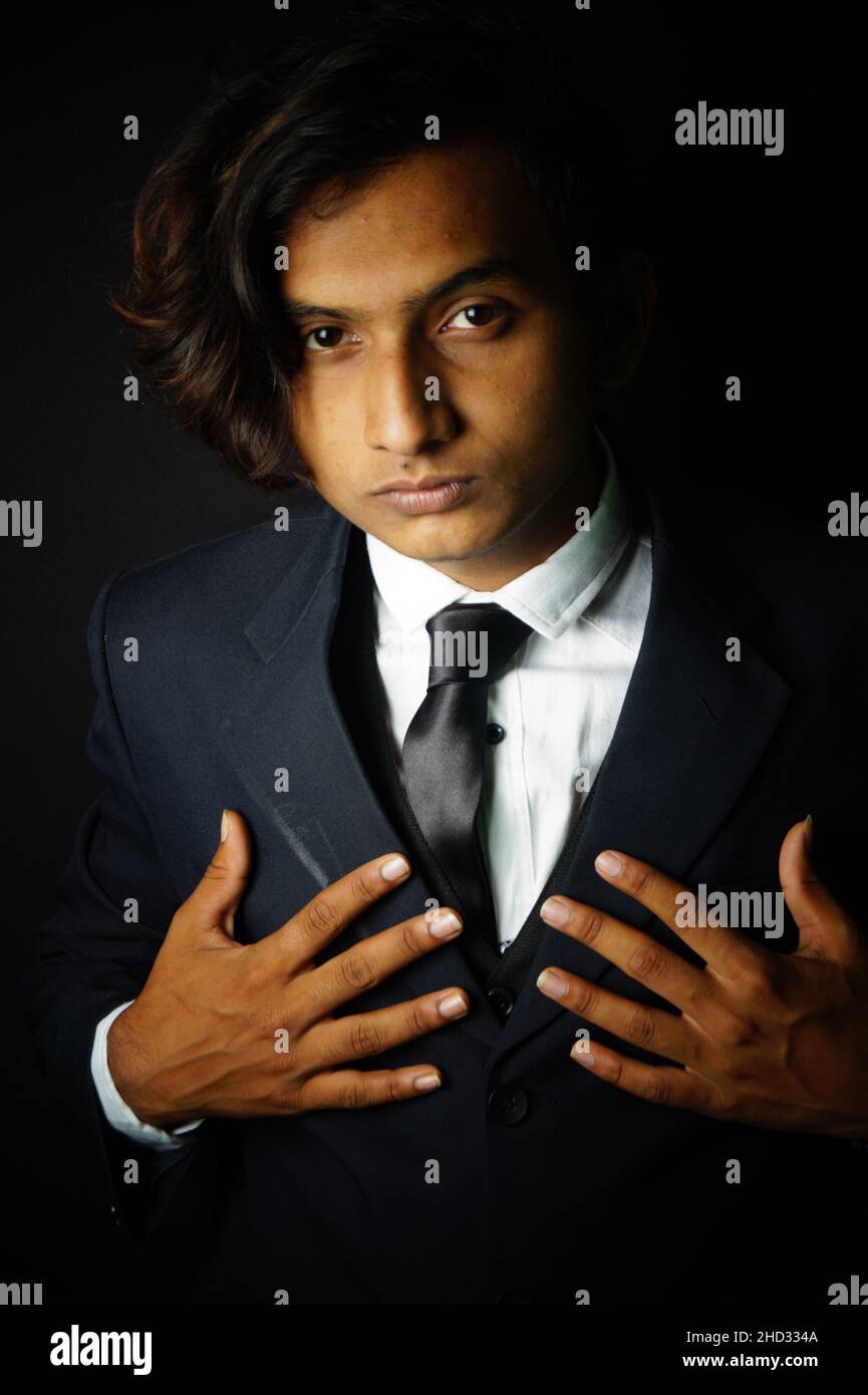 Vertical shot of a handsome Indian man wearing a classy suit and tie on ...