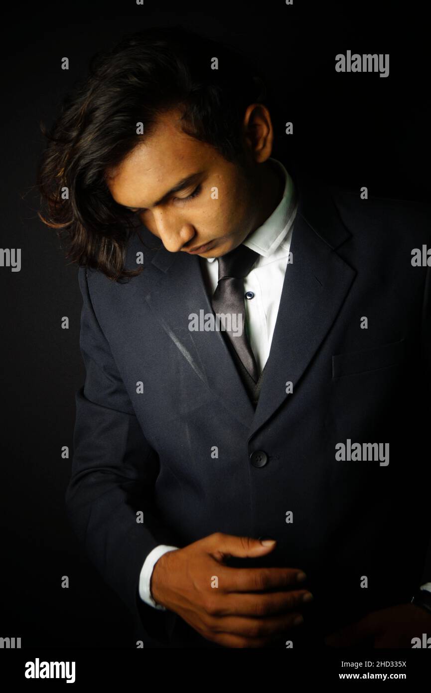 Vertical shot of a handsome Indian man wearing a classy suit and tie on ...