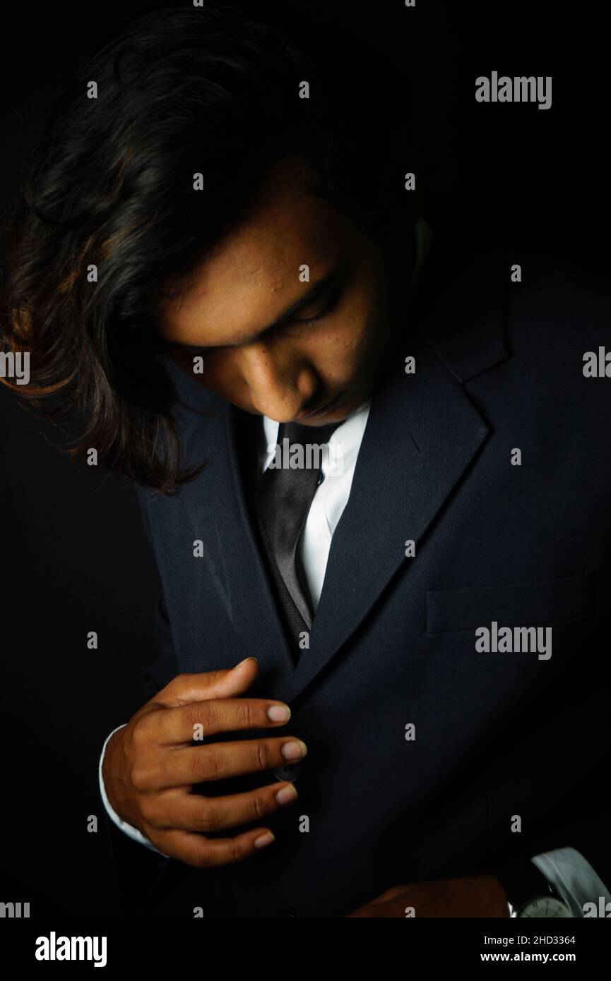 Vertical shot of a handsome Indian man wearing a classy suit and tie on ...