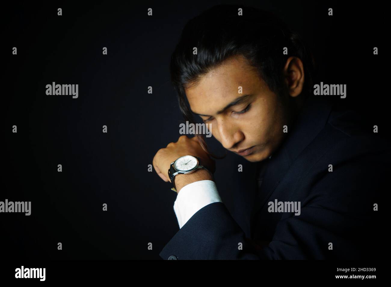 Closeup shot of an Indian man wearing a classy suit and watch on a ...