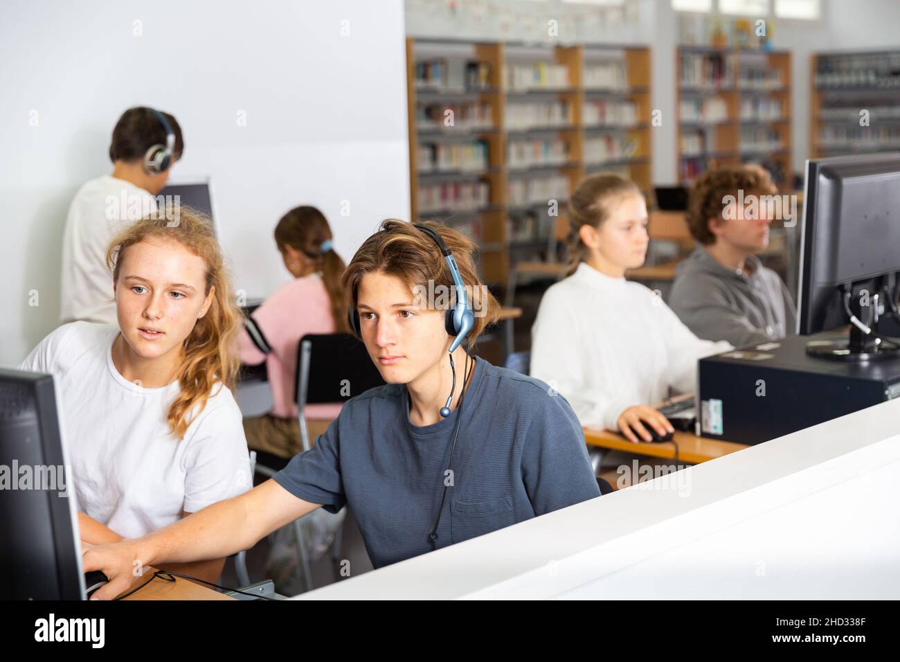 Teenage student in headphones at the computer in school class Stock ...
