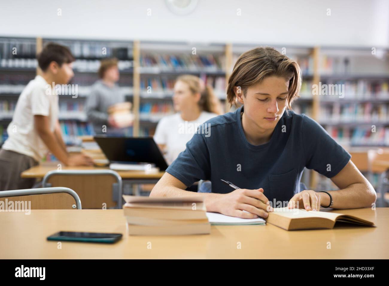 Fifteen-year-old schoolboy writes an synopsis Stock Photo - Alamy