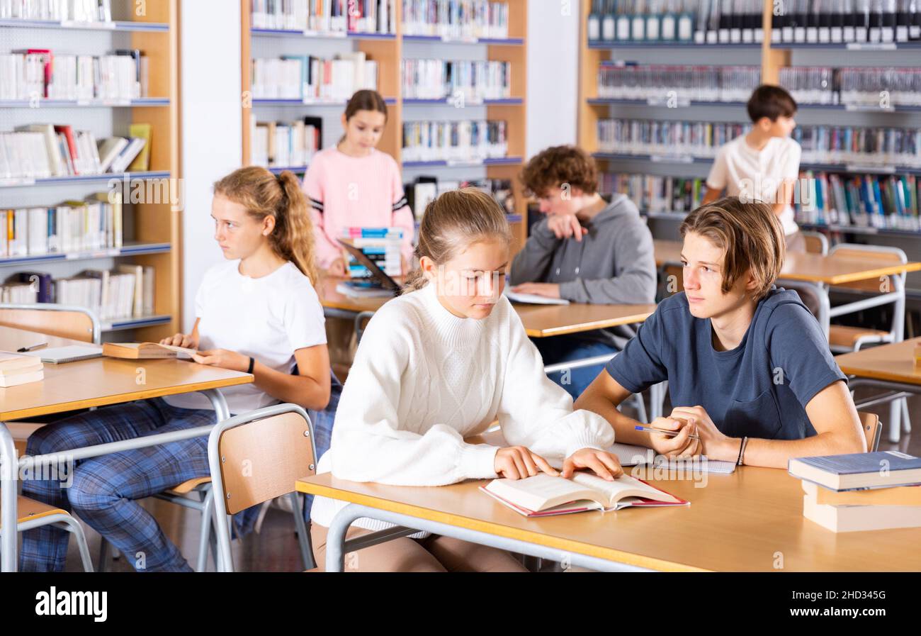 Schoolchildren write out a synopsis from the textbook Stock Photo - Alamy