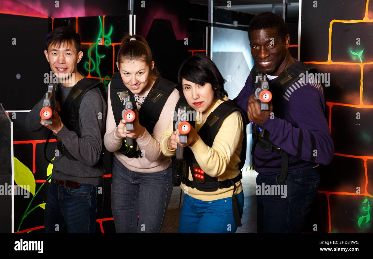 people of different nationalities with laser pistols posing together ...
