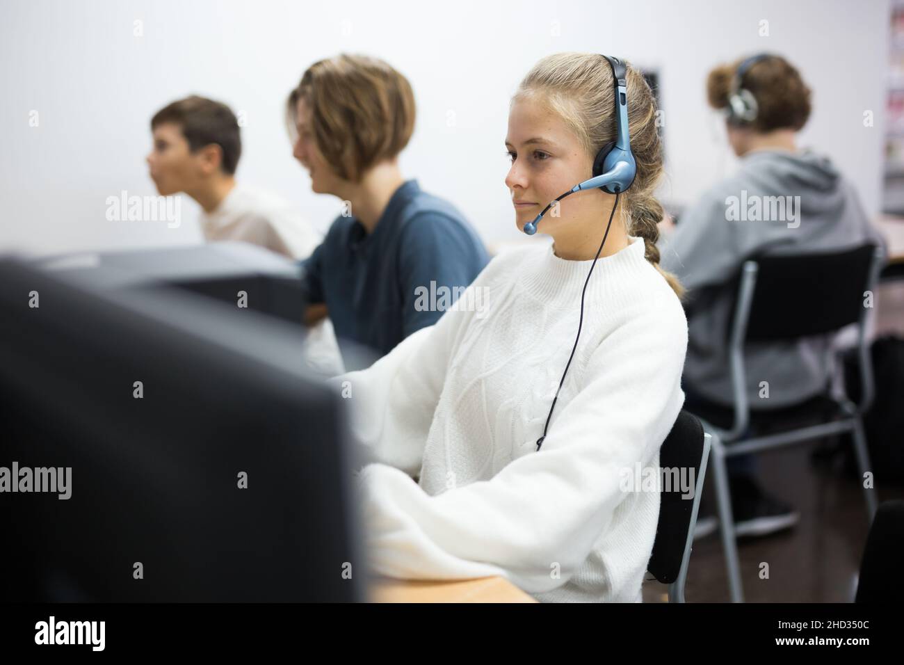 Teenager girl using computer in classroom Stock Photo - Alamy