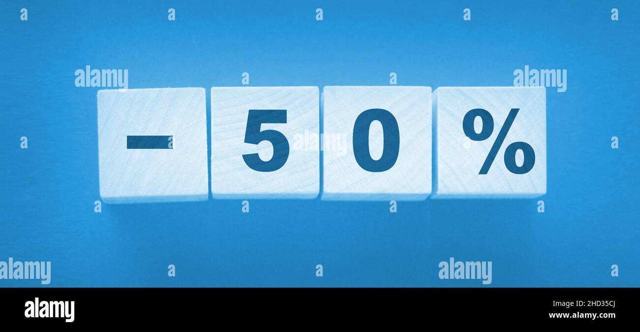 Minus 50 percent on wooden blocks on black background. Sale business ...