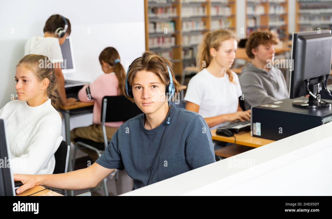 Teenage student in headphones at the computer in school class Stock ...