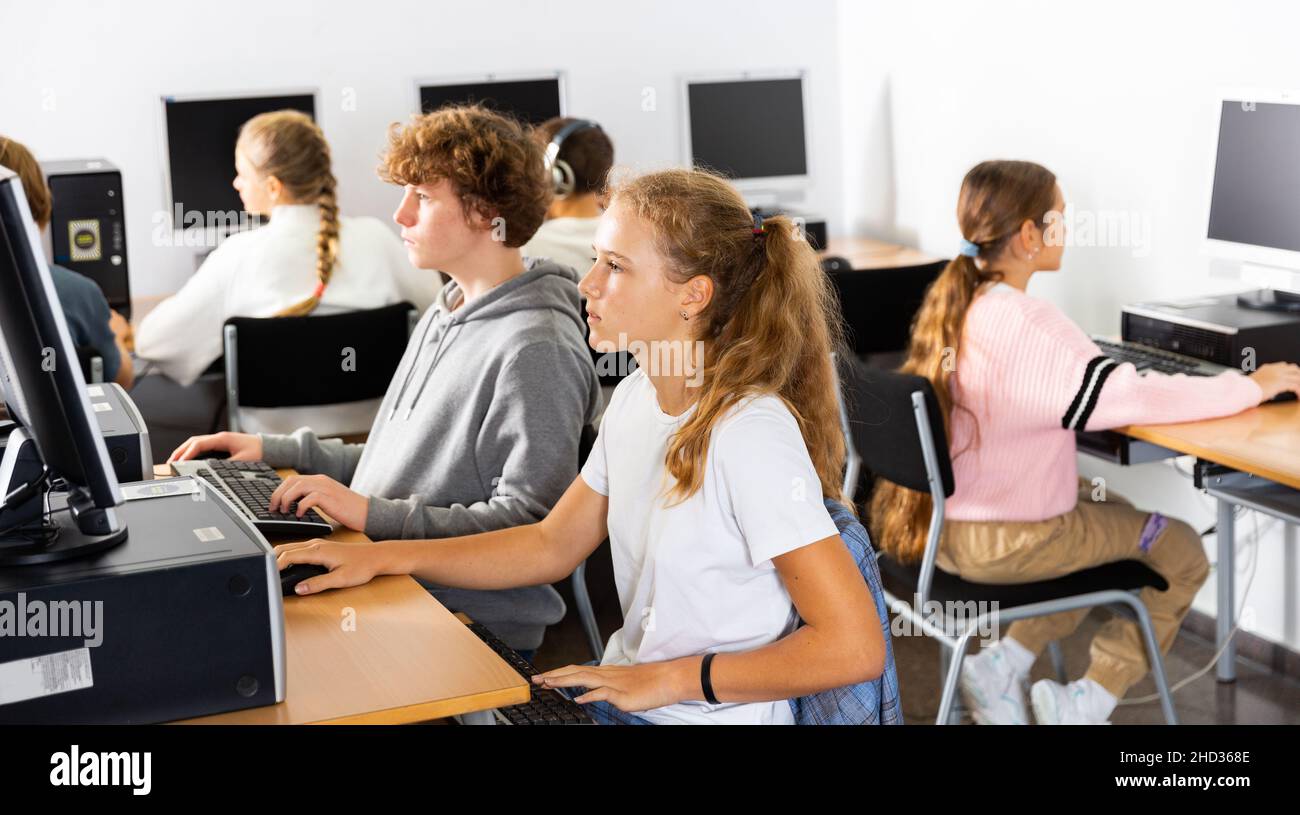 Young boys and girls using computers in classroom Stock Photo - Alamy