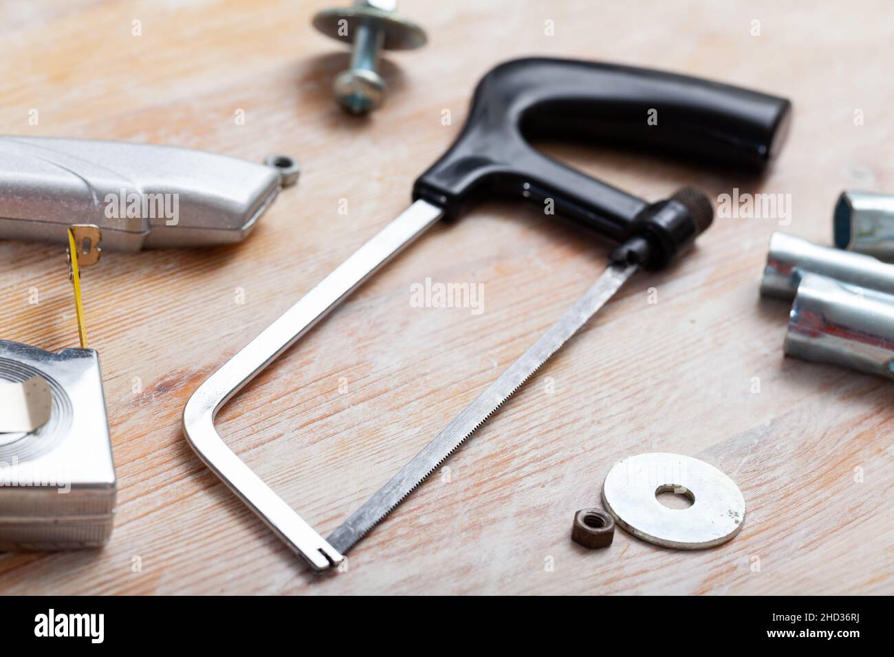 Top view of hacksaw surrounded by various tools Stock Photo - Alamy