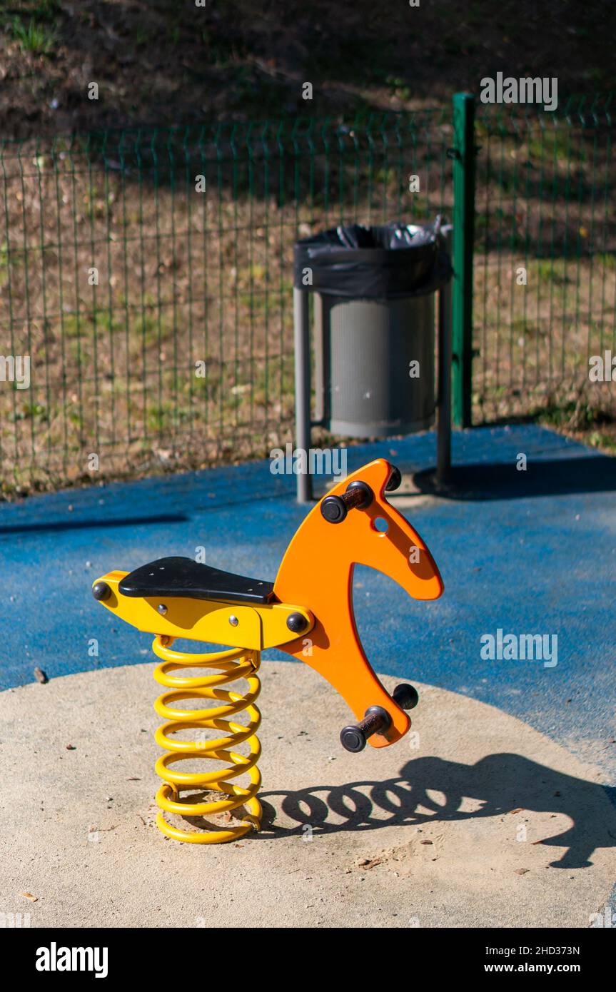An orange horse equipment in a playground Stock Photo - Alamy