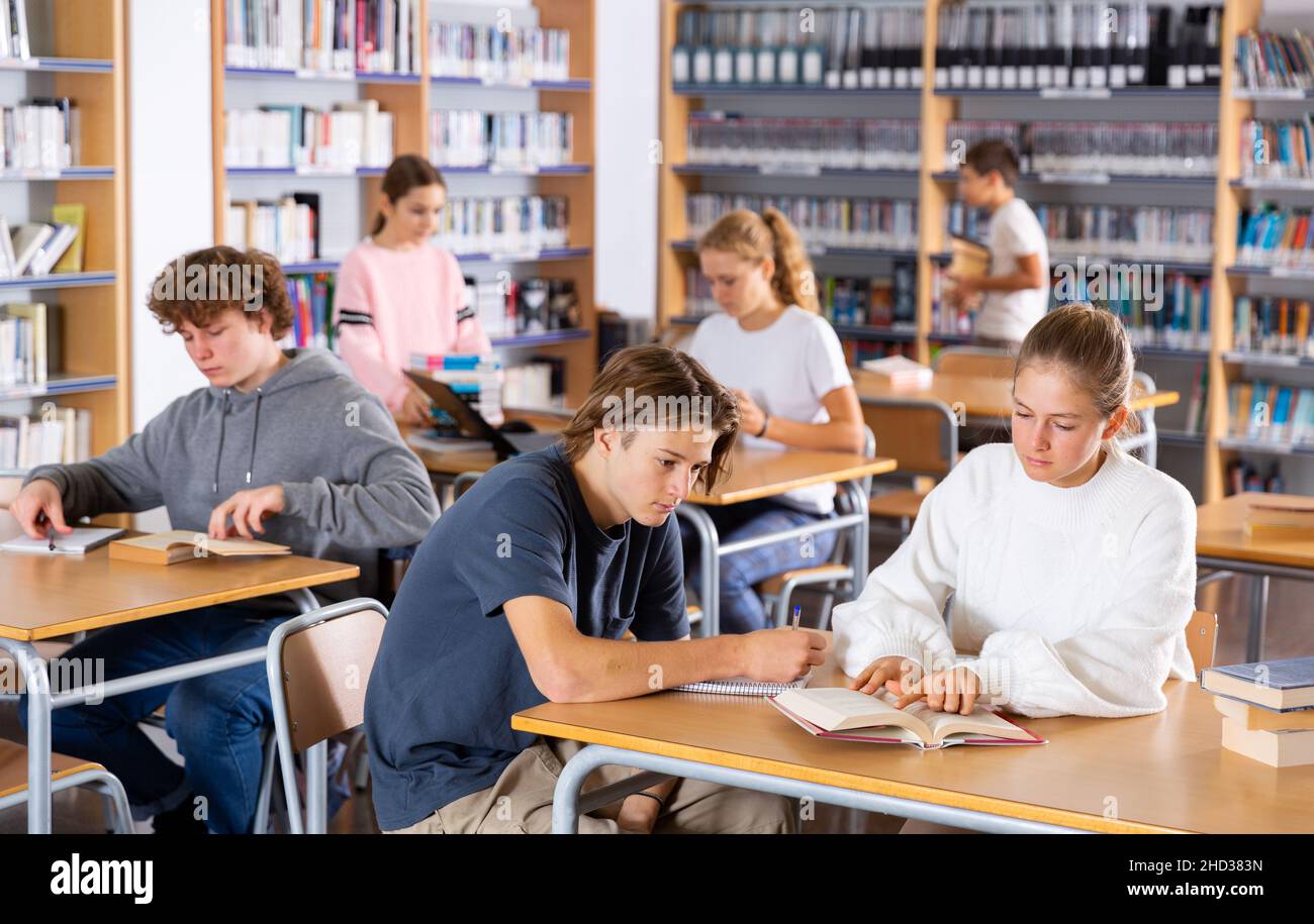 Schoolchildren write out a synopsis from the textbook Stock Photo - Alamy