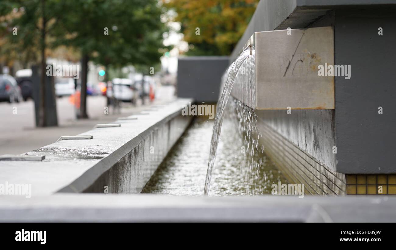 Side shallow focus view of a public water blade with flowing water ...