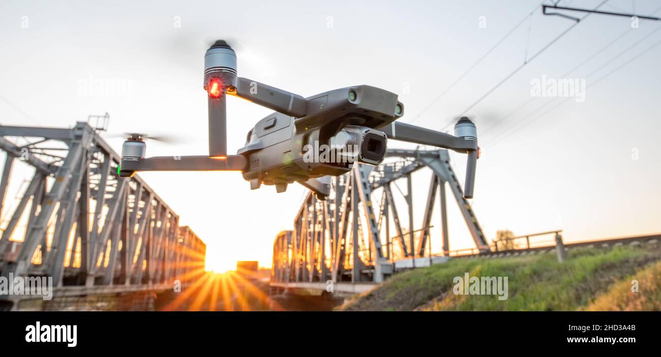The use of drones in industry. The drone inspects the railway bridge at ...