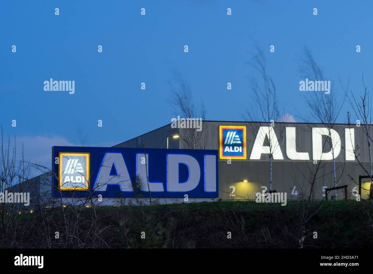 Store logo at night for ALDI supermarket England UK Stock Photo - Alamy