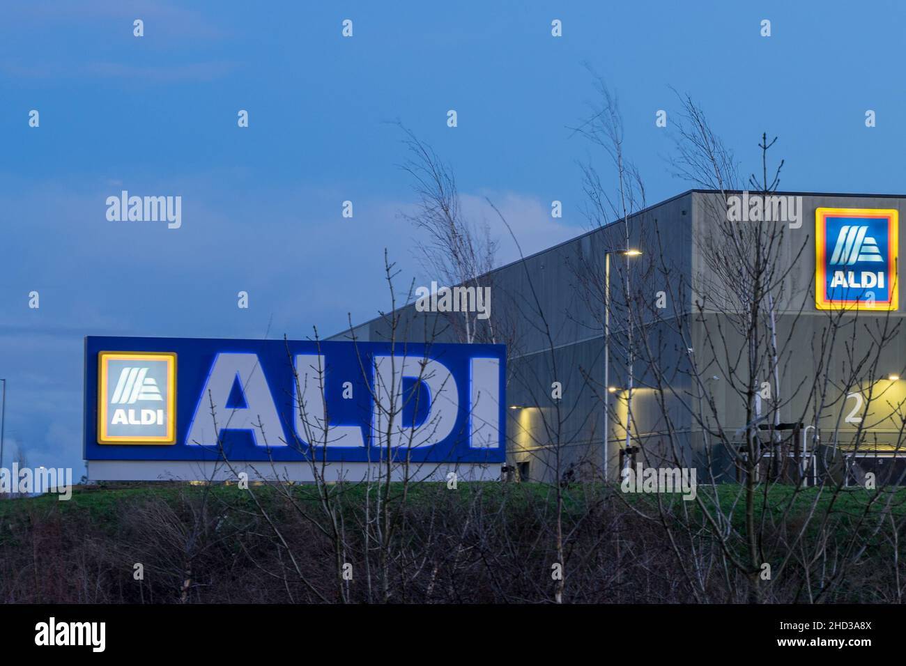 Store logo at night for ALDI supermarket England UK Stock Photo - Alamy