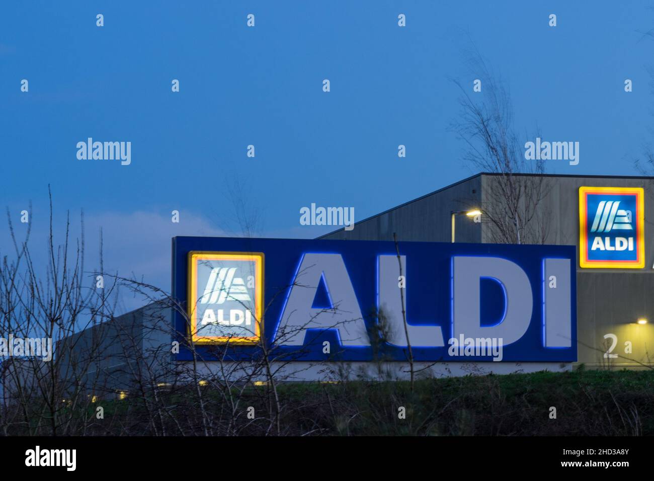 Store logo at night for ALDI supermarket England UK Stock Photo - Alamy