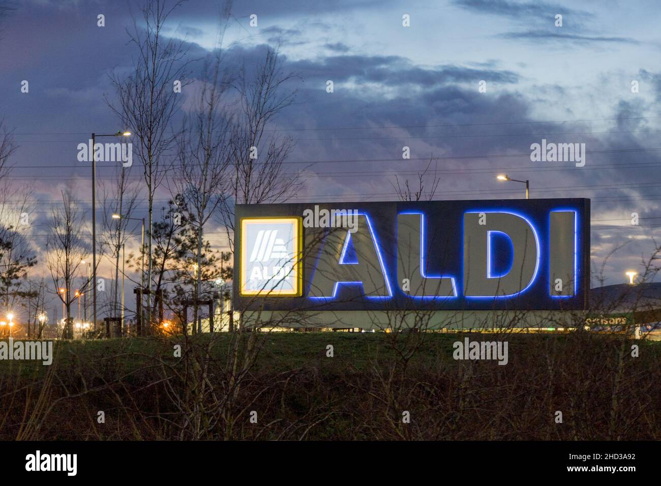 Store logo at night for ALDI supermarket England UK Stock Photo - Alamy