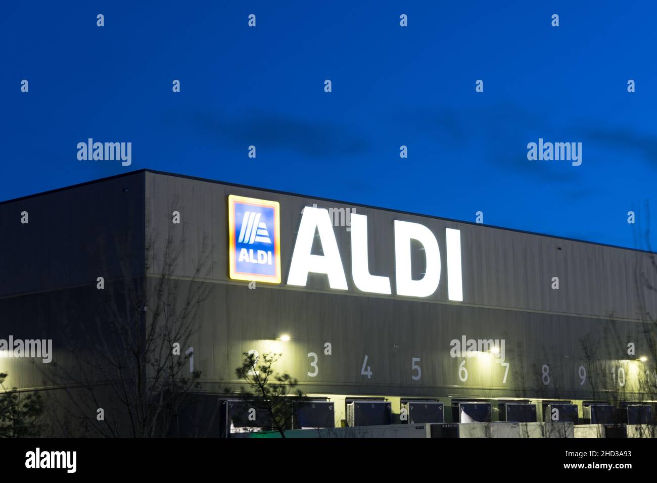 Store logo at night for ALDI supermarket England UK Stock Photo - Alamy