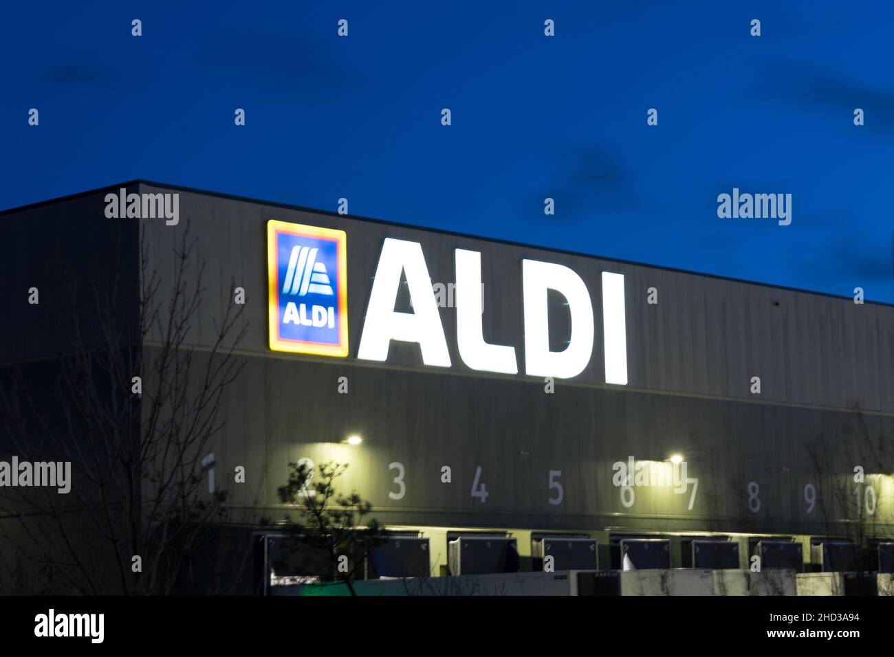 Store logo at night for ALDI supermarket England UK Stock Photo - Alamy