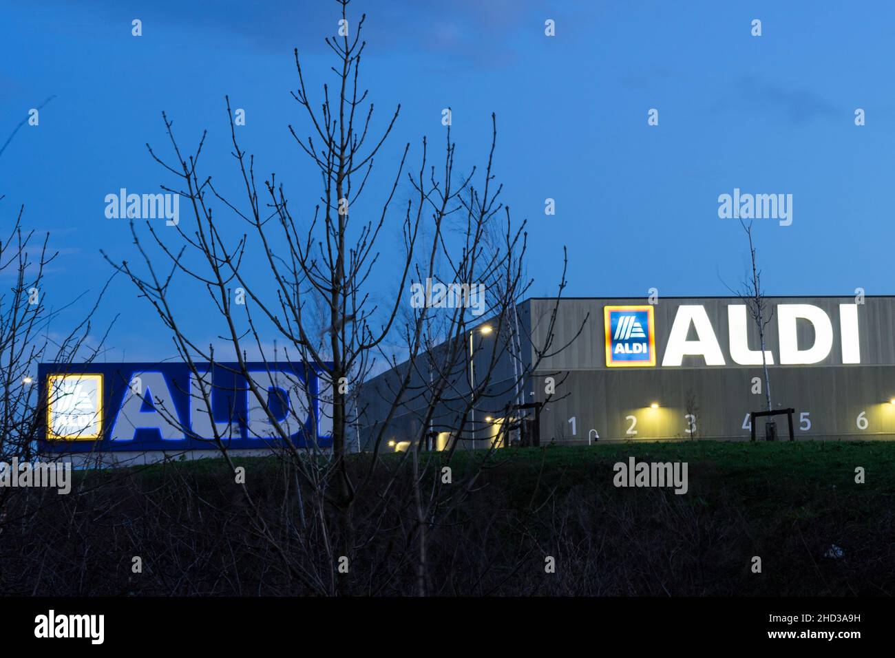 Store logo at night for ALDI supermarket England UK Stock Photo - Alamy