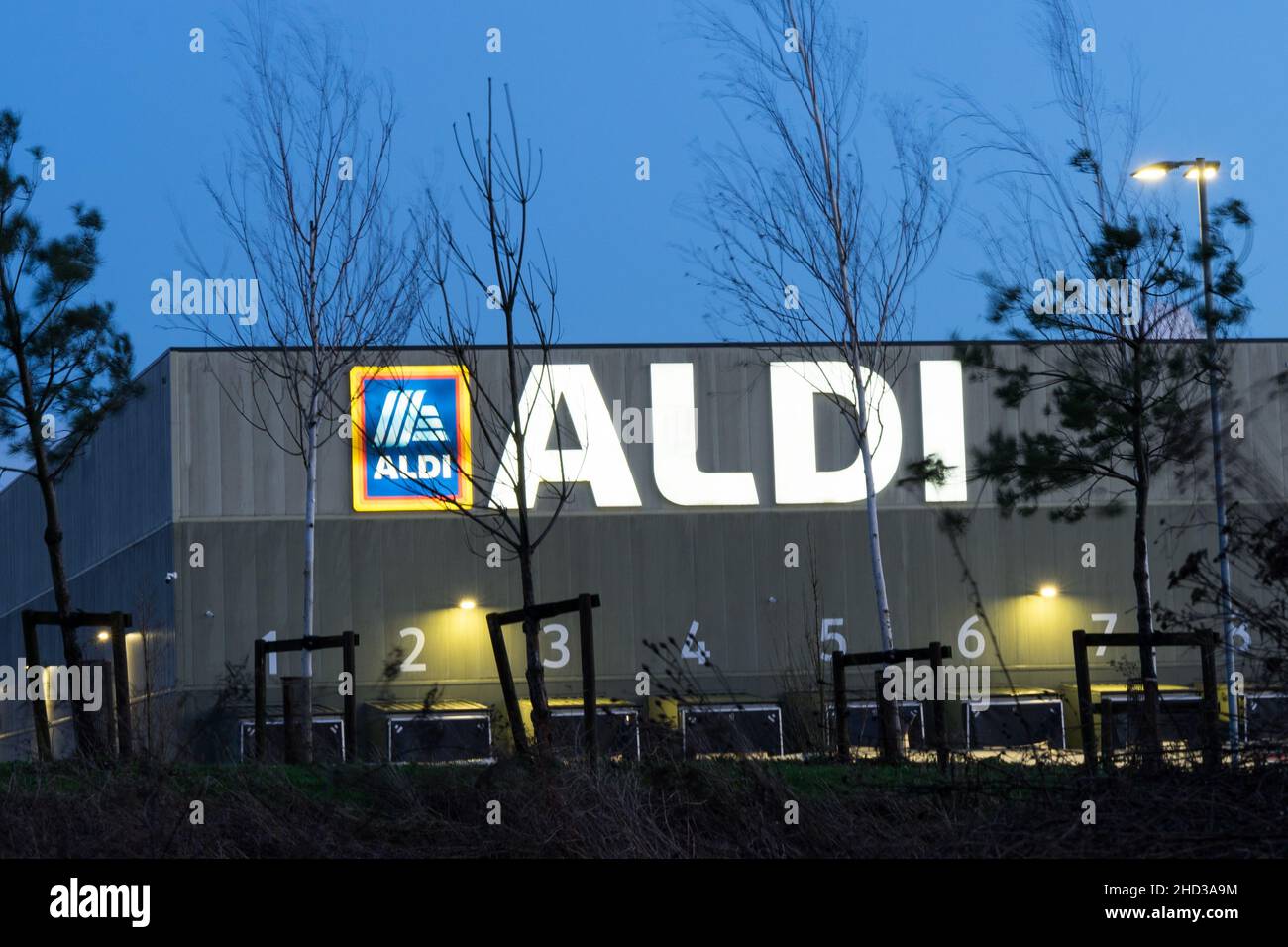 Store logo at night for ALDI supermarket England UK Stock Photo - Alamy