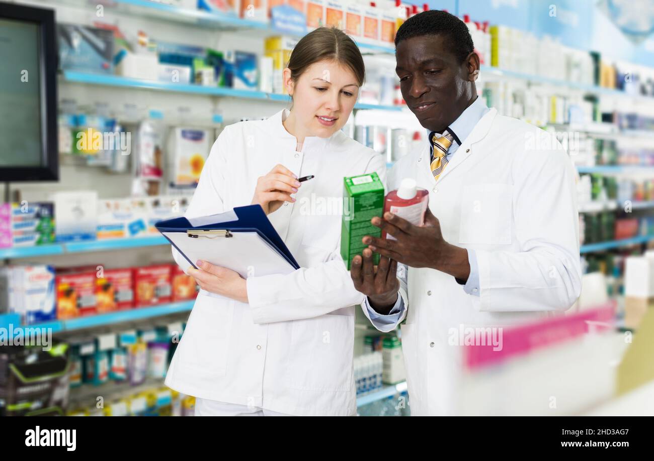 pharmacists taking inventory of medicines in pharmacy Stock Photo - Alamy