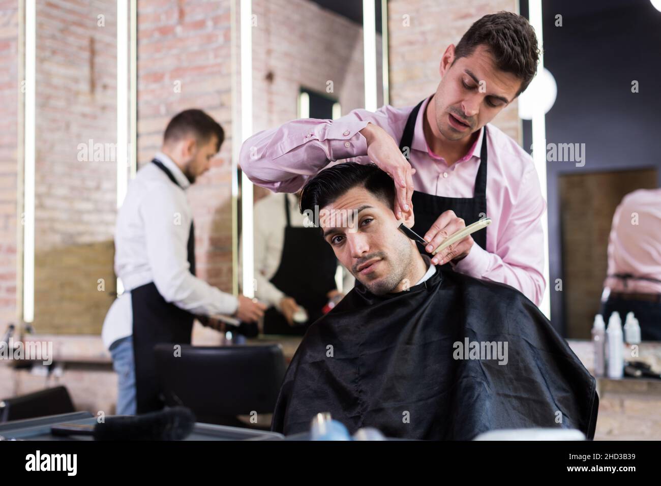Male getting shave with straight razor in salon Stock Photo - Alamy