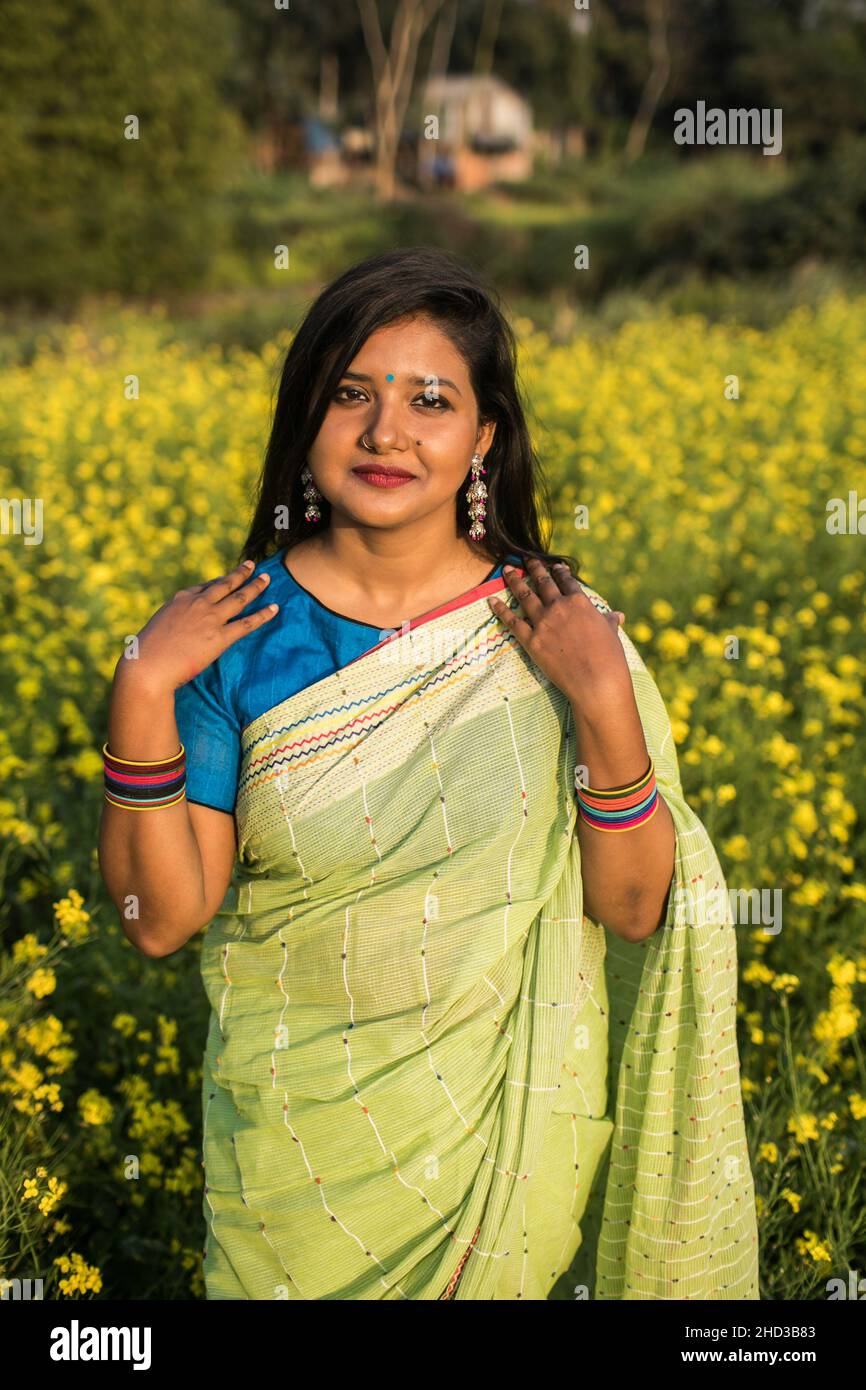 A woman poses for a photo at a yellow Mustard Field on the outskirts of ...